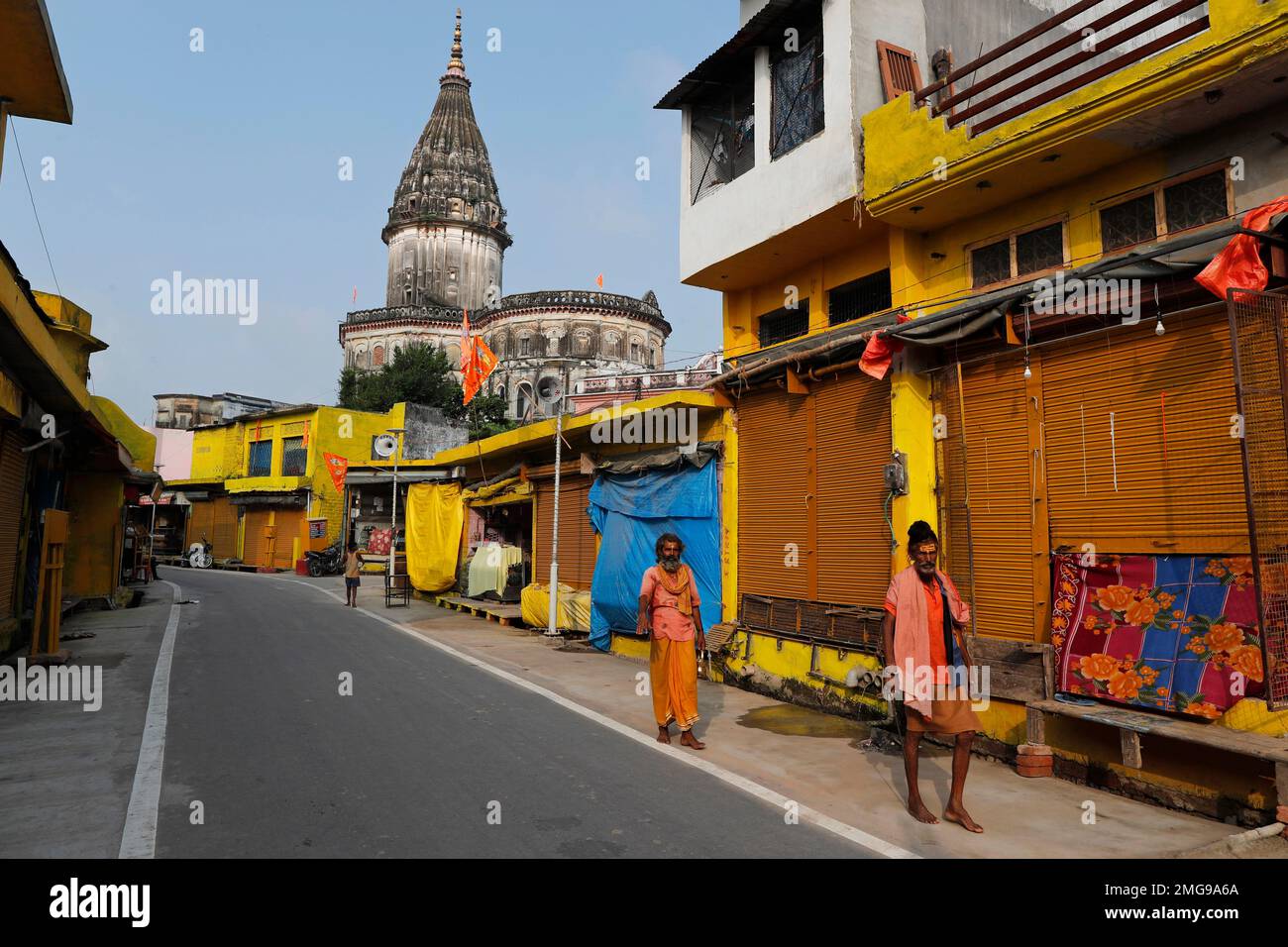 Sadhus walk by a road ahead of a groundbreaking ceremony of a temple ...