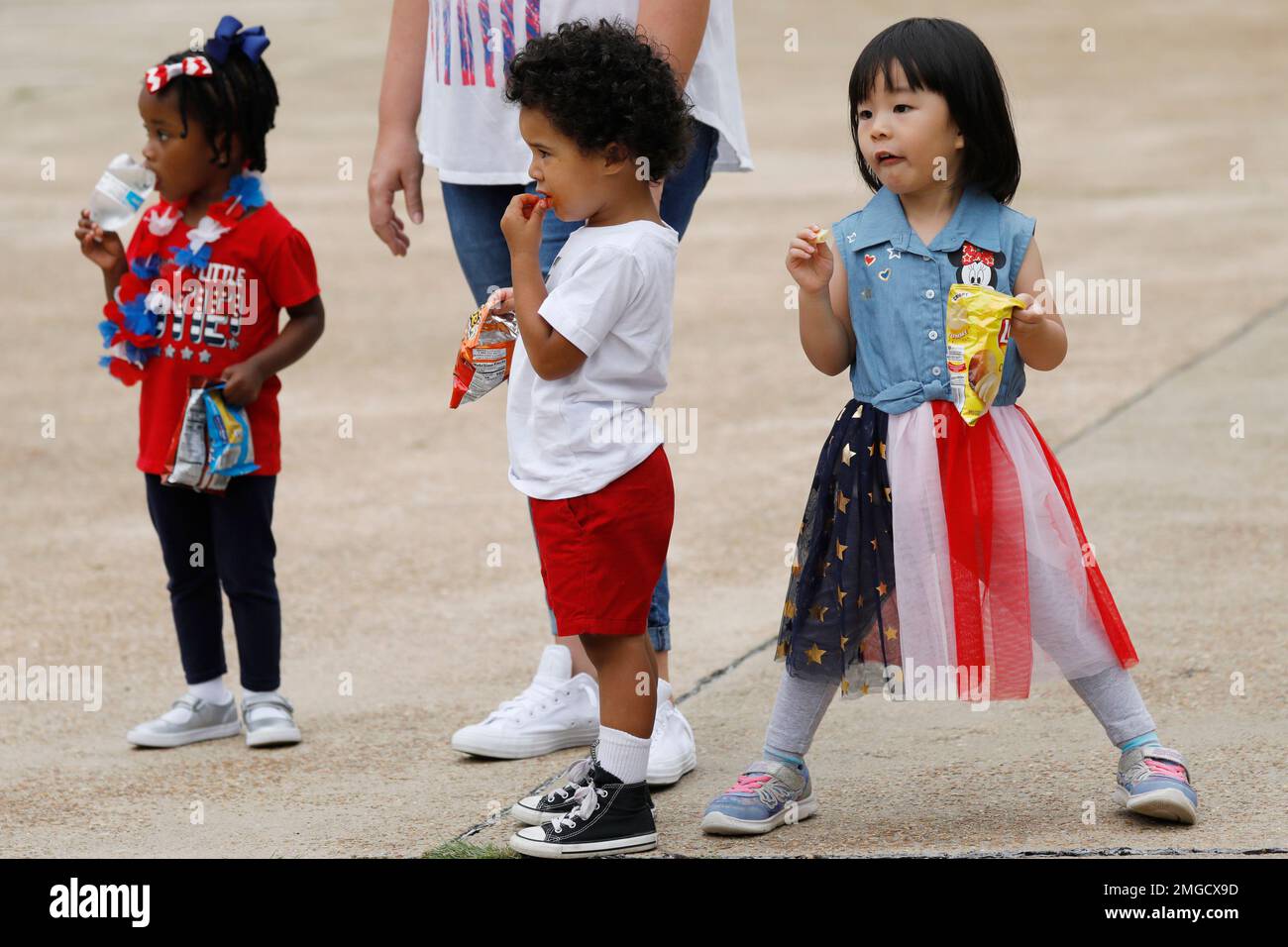 Makia Alexander, center, Landon Williams, left, and Mia Qi, all 3, keep ...