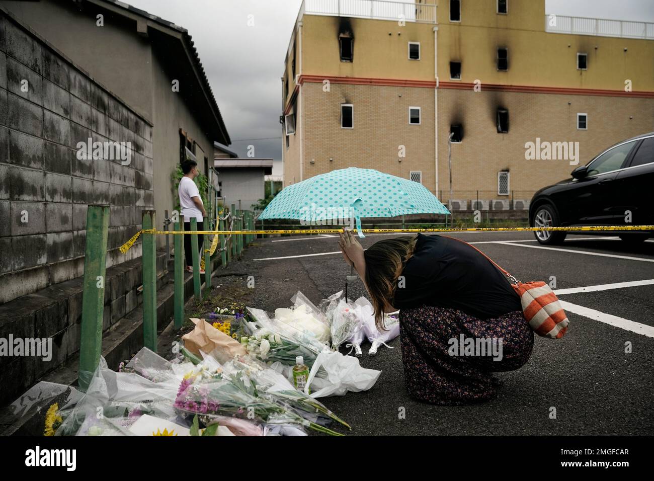 FILE - In this July 19, 2019, file photo, a woman prays at a makeshift ...