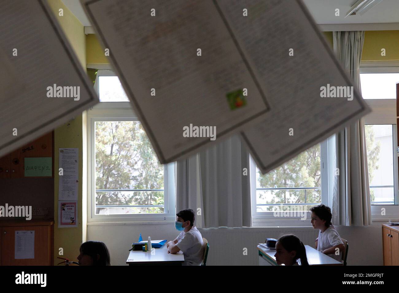 Students are taught in a classroom where social distancing practices ...