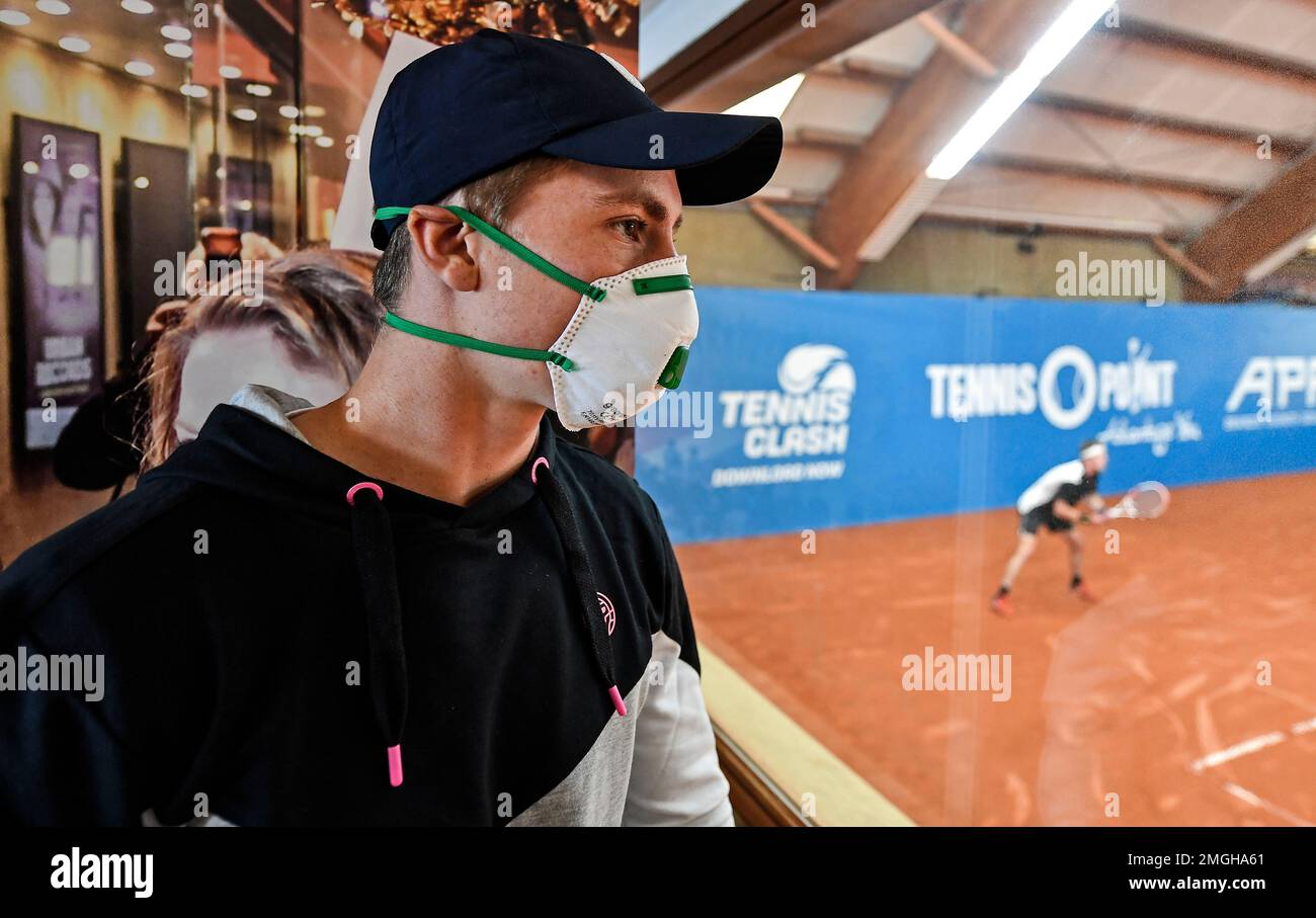 Germany's tennis player Florian Broska wears a face mask while watching ...