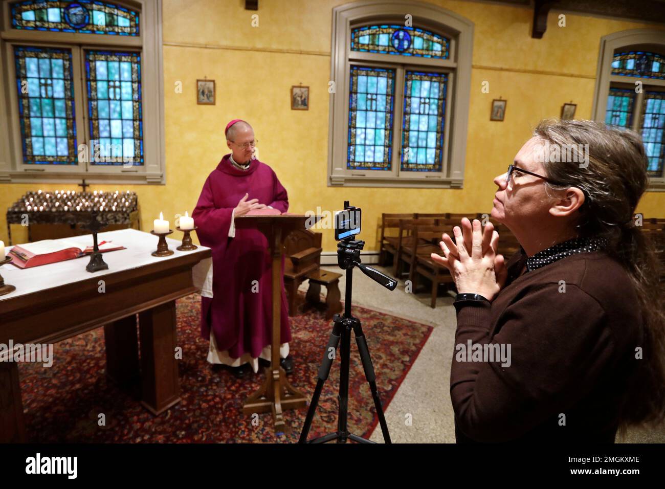 Maria Laughlin, right, prepares to start her phone to begin a live ...