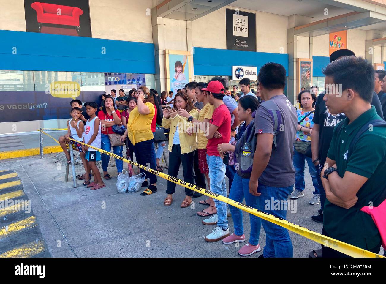 People Stand Behind A Police Tape Outside The V Mall Where Gunshots