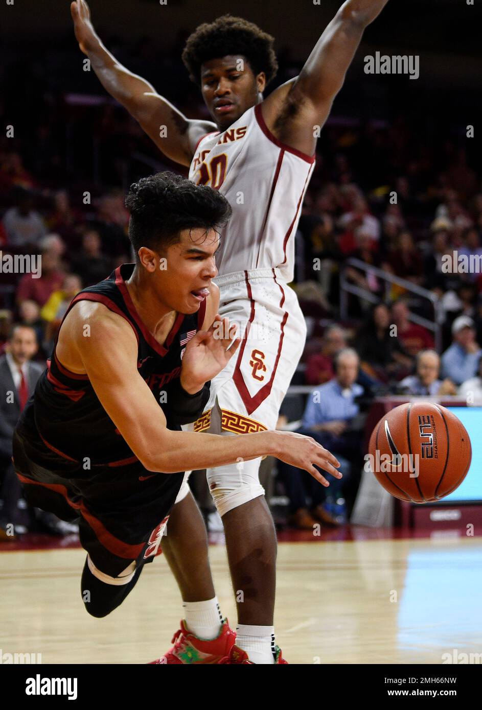 Stanford guard Tyrell Terry, left, dives while passing the ball as ...