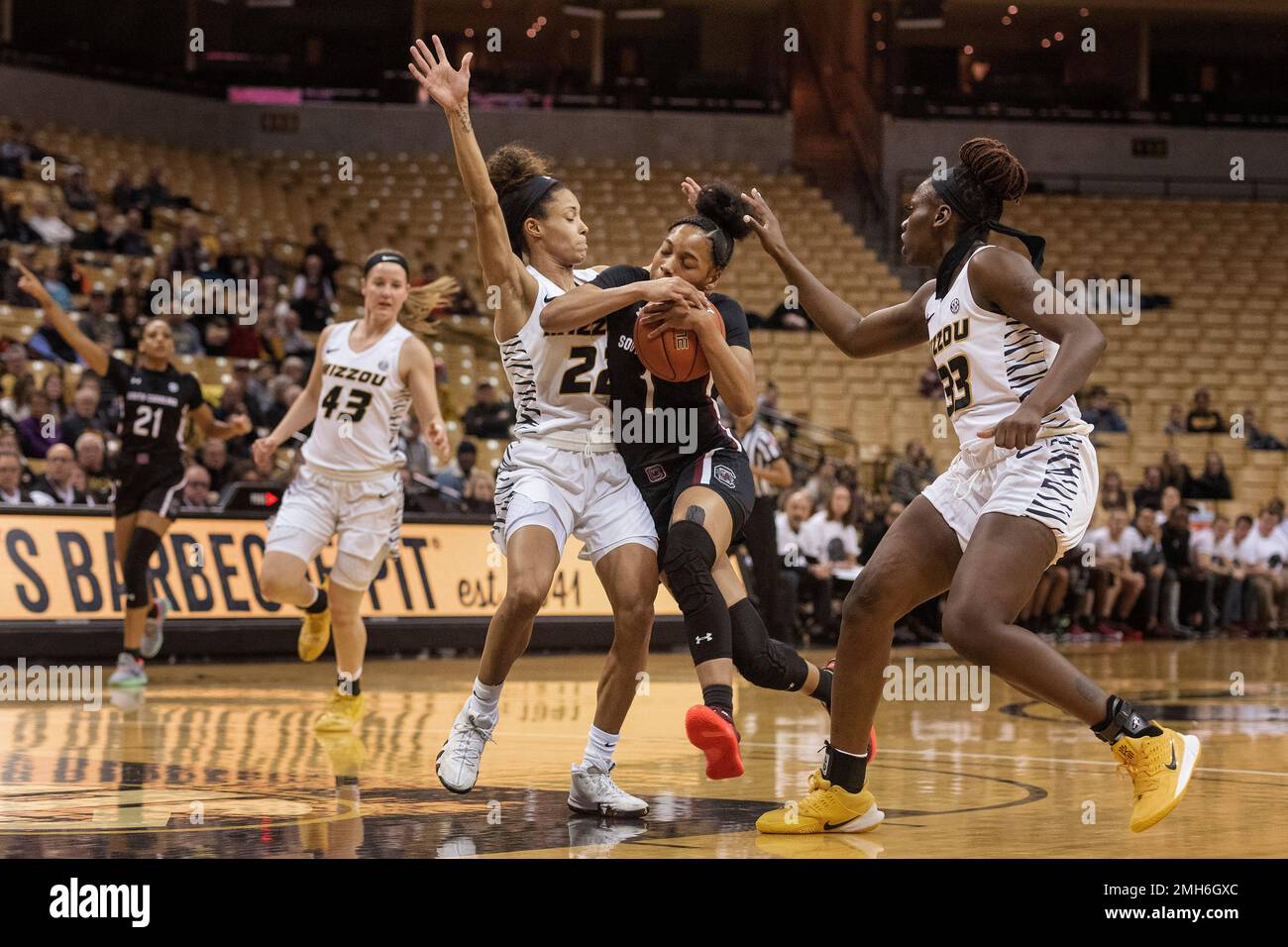 South Carolina's Zia Cooke, center, drives between Missouri's Aijha ...