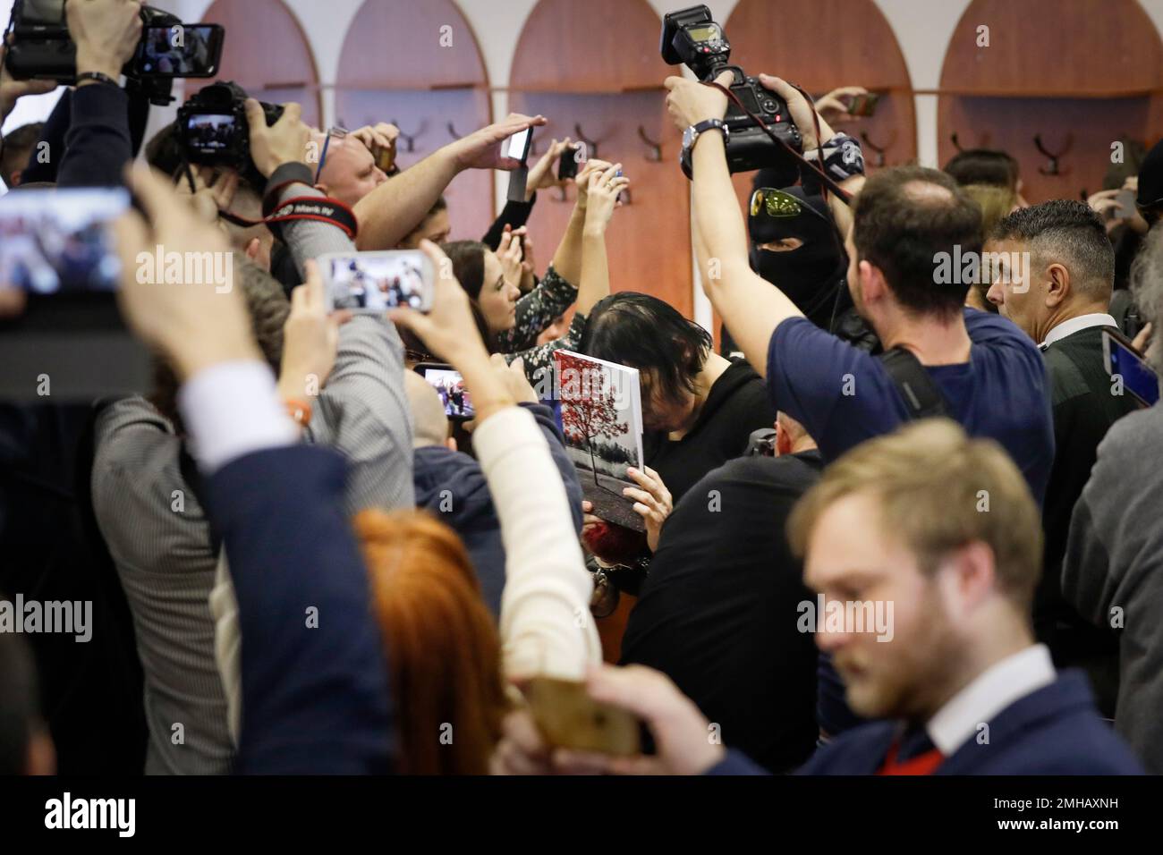 Alena Zsuzsova covers her face as she is escorted in a courtroom ahead ...