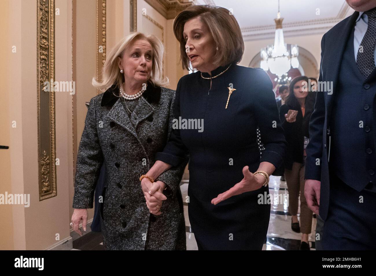 Speaker of the House Nancy Pelosi, D-Calif., holds hands with Rep ...