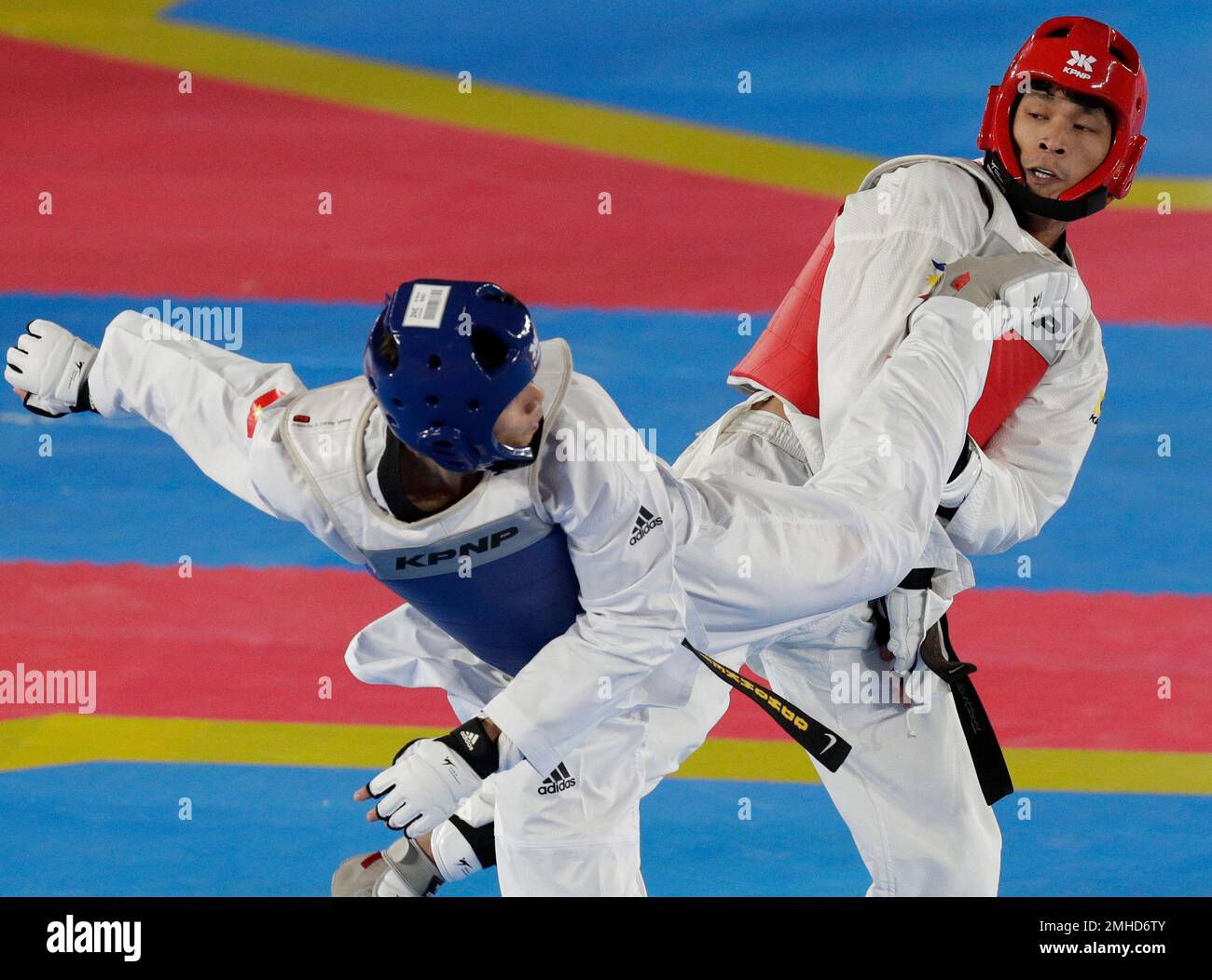 Vietnam's Van Duy Nguyen, left, lands a turning sidekick to the body of ...