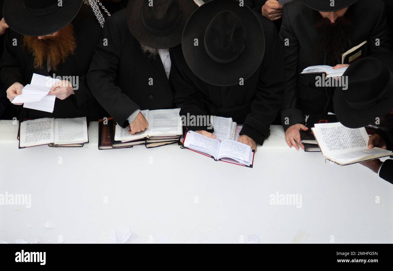 In this Nov. 22, 2019, photo, Hasidic leaders read personal notes and ...