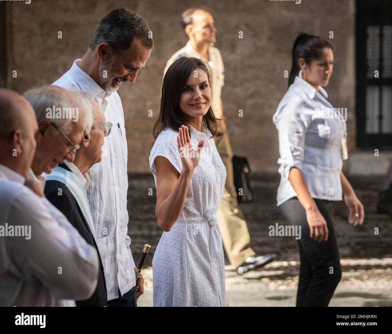 Spain's Queen Letizia greets people while walking with King Felipe VI ...