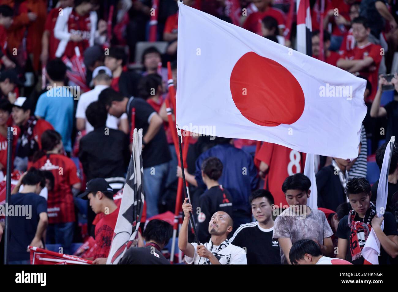 A fan of Japan's Urawa Reds waves the Japanese national flag prior to ...