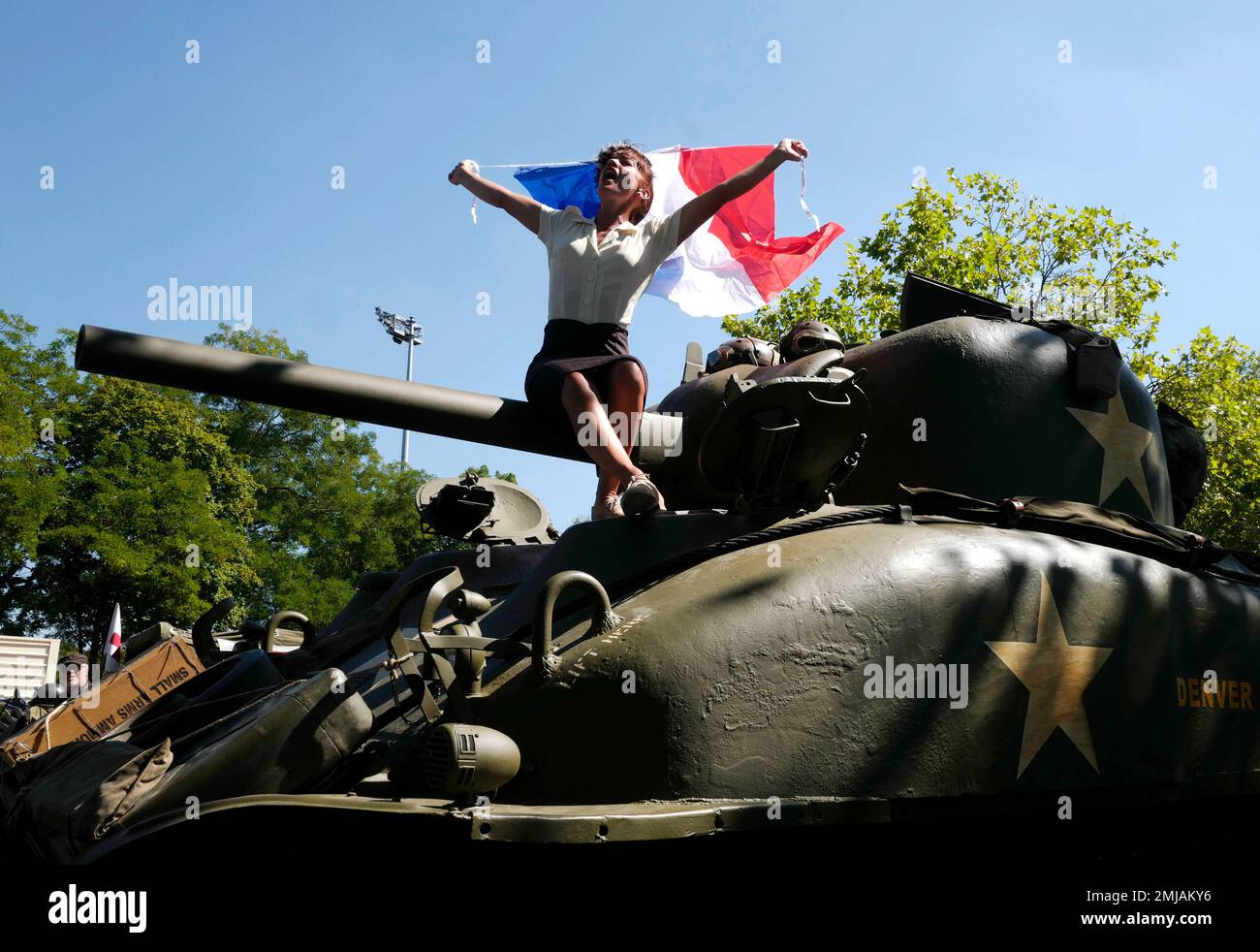 A woman waves a French flag during celebrations of the liberation of ...