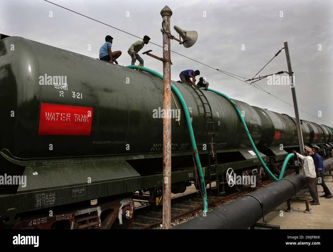 In this Wednesday, July 17, 2019, photo, workers fill wagons of a train ...