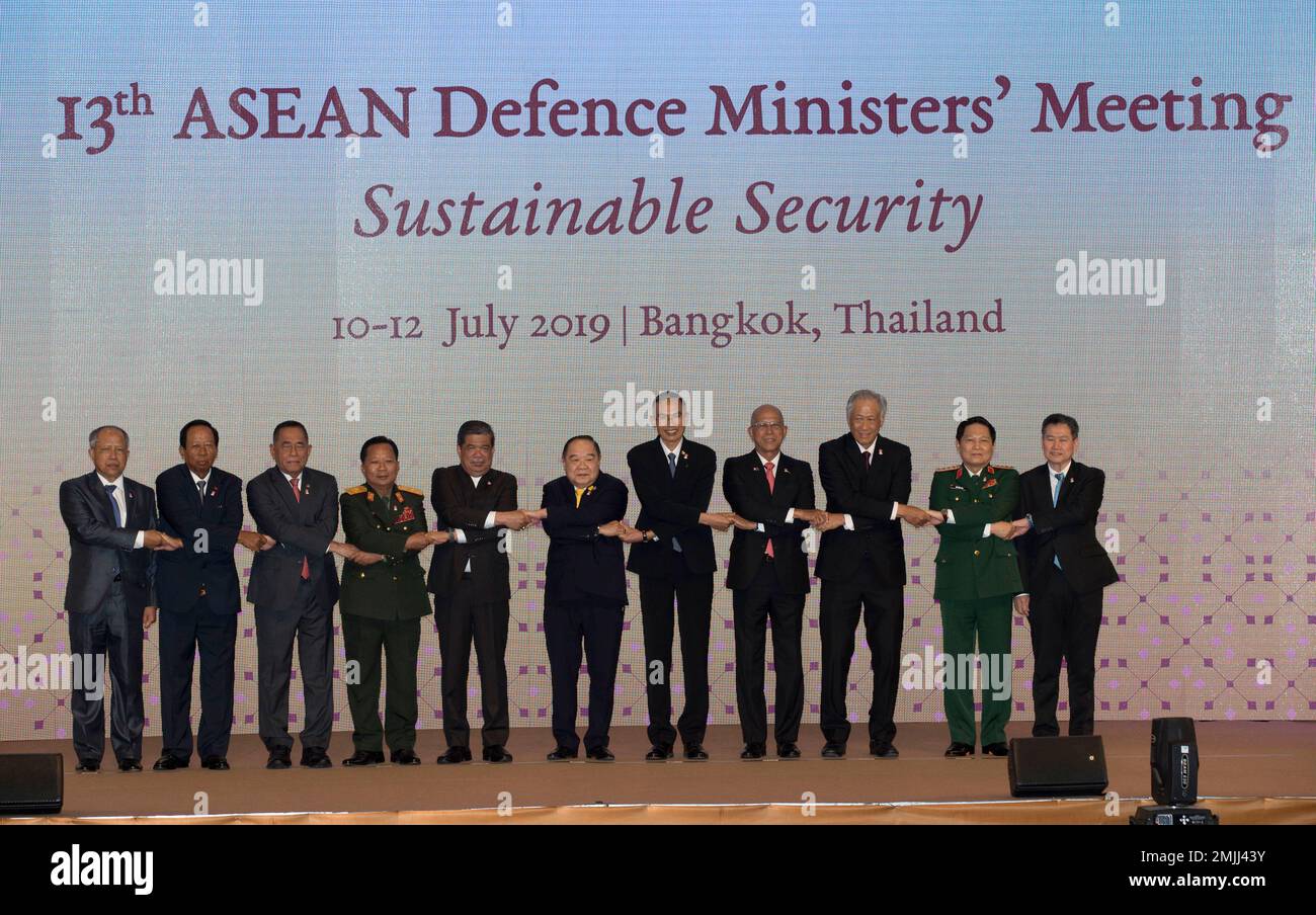 ASEAN defense ministers shake hands for a group photo ahead of the ...