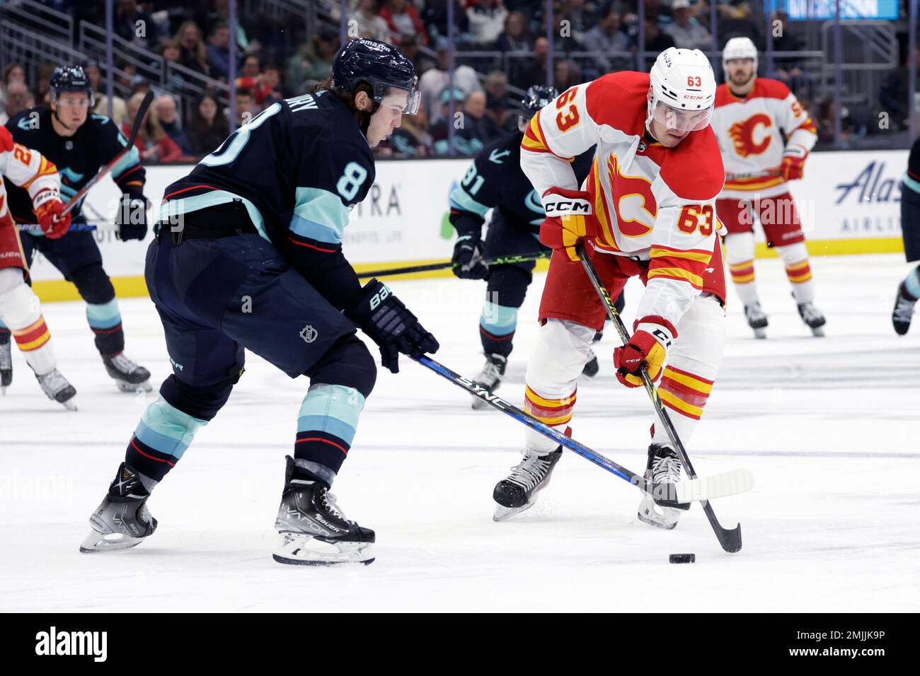 Calgary Flames center Adam Ruzicka (63) passes the puck under the stick ...