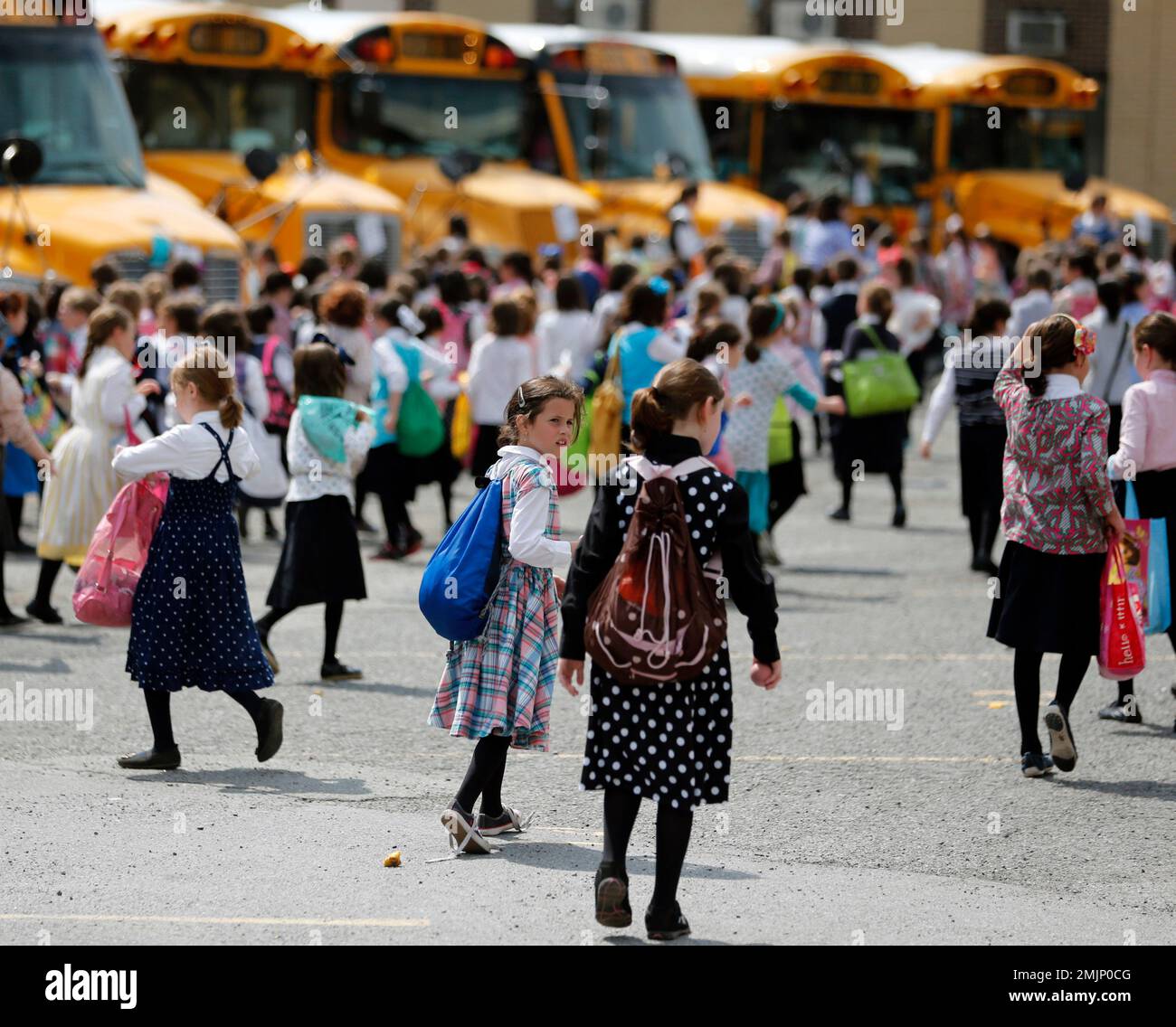 FILE - In this July 1, 2014 file photo, Orthodox Jewish girls walk to ...