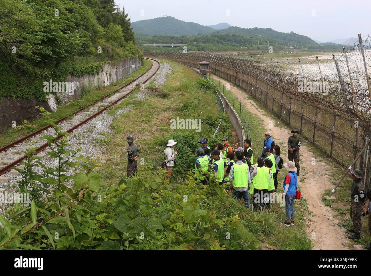 Hikers are briefed by a guide as they visit the DMZ Peace Trail in the ...