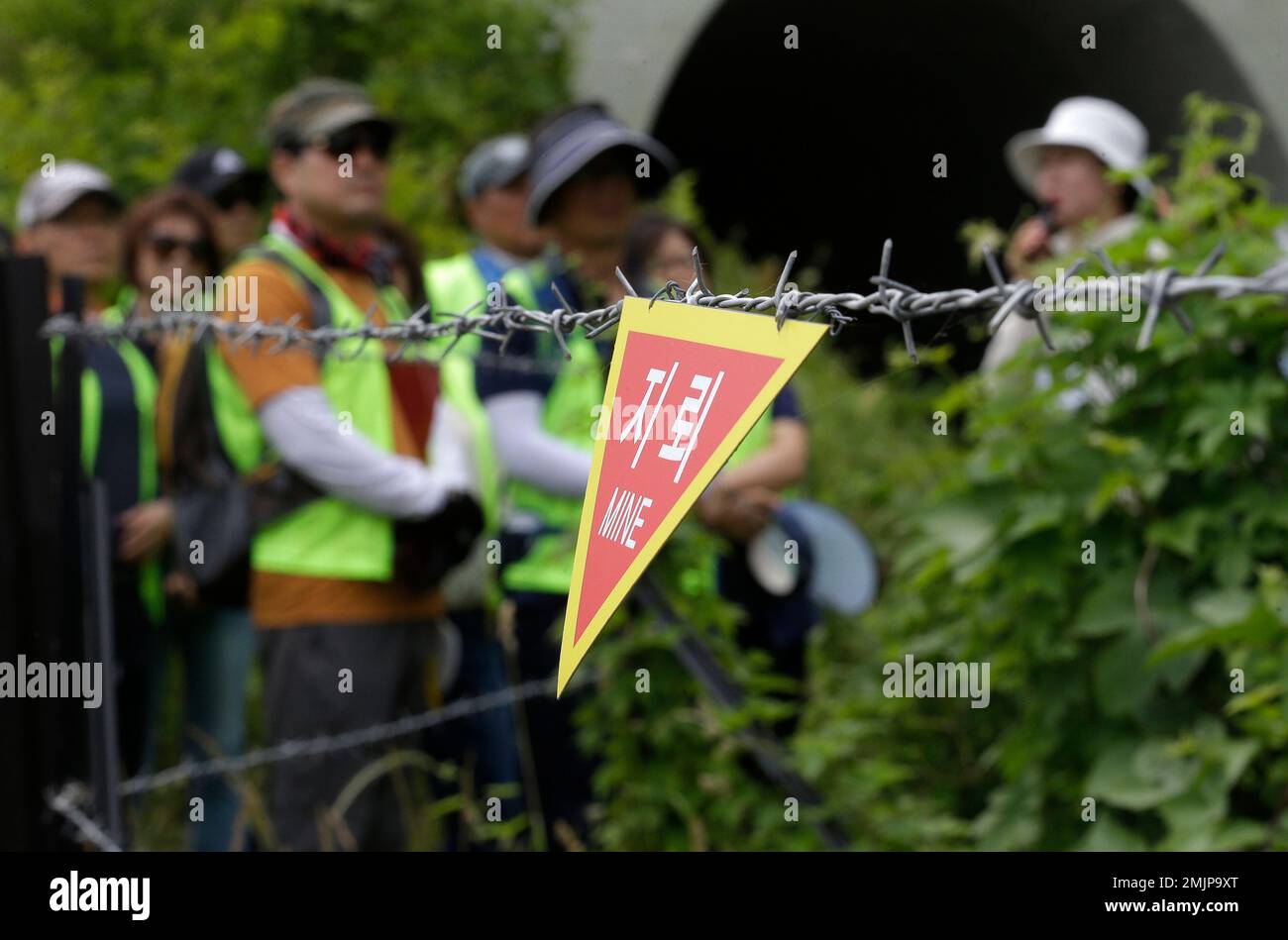 A sign indicating land mines is seen while hikers visit the DMZ Peace ...