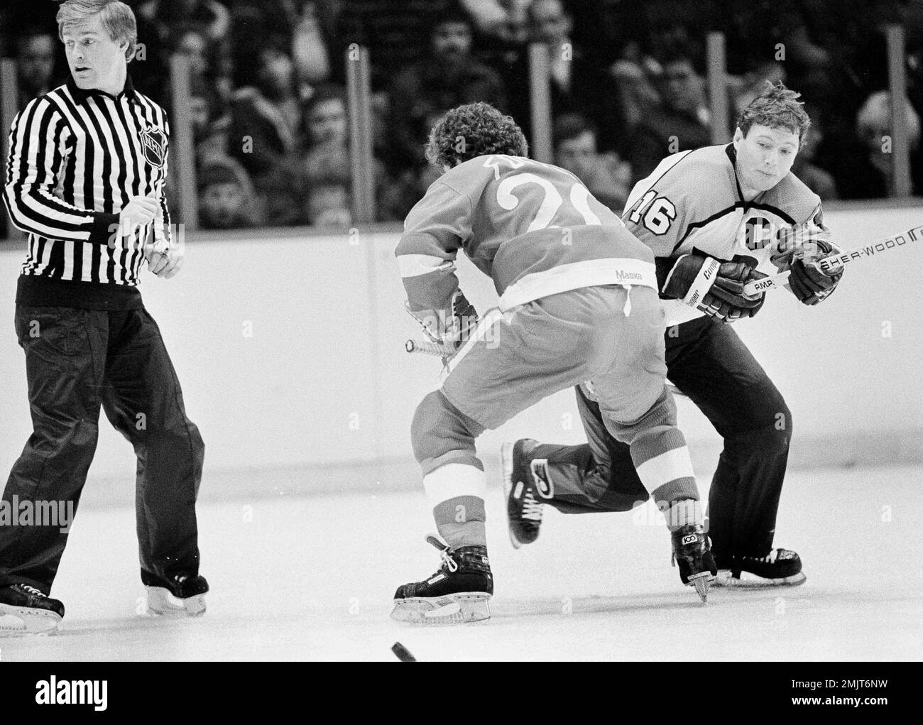 Philadelphia Flyers' center Bobby Clarke, right, chases the puck around ...