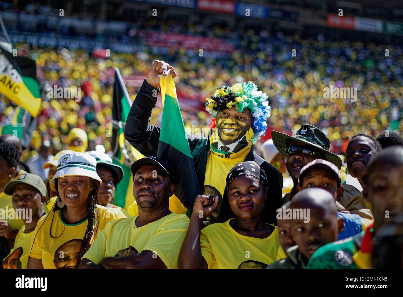 A supporter of the ruling African National Congress (ANC) wears a mask ...