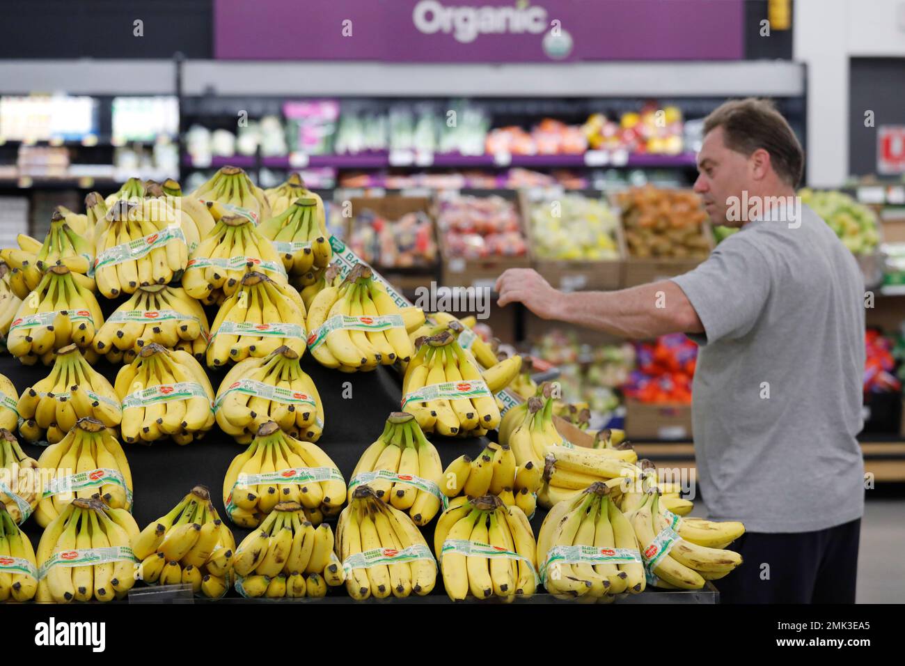 A customer shops for bananas at a Walmart Neighborhood Market ...