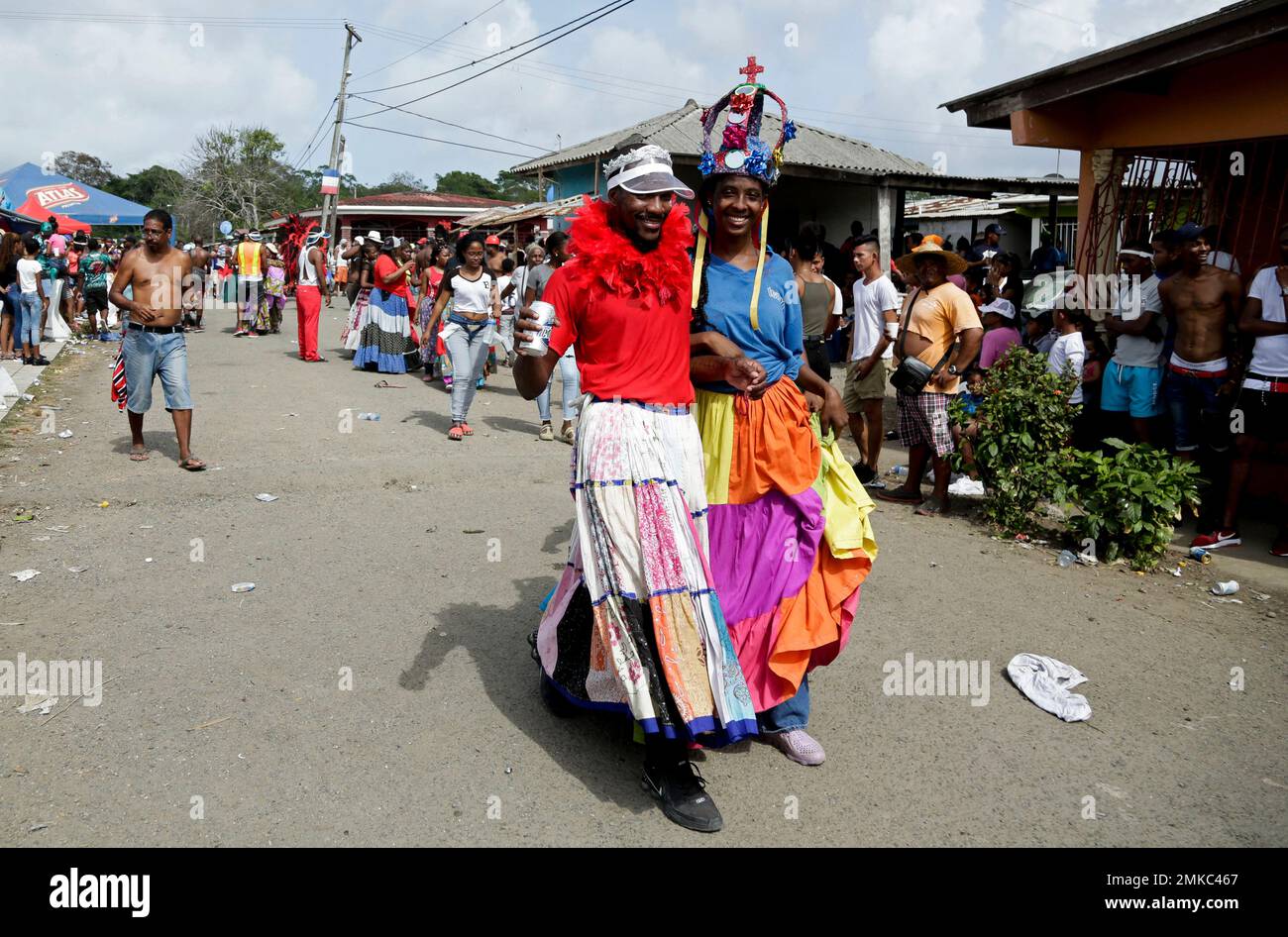 A woman with a crown who represents the Congo queen walks with a fellow ...