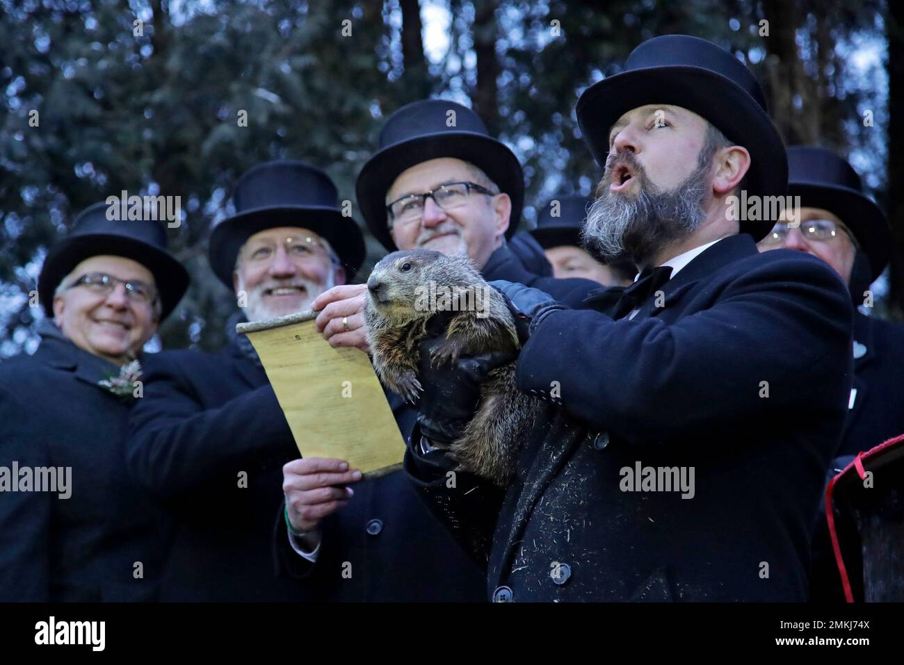 Groundhog Club vice-president Jeff Lundy, center, reads the weather ...