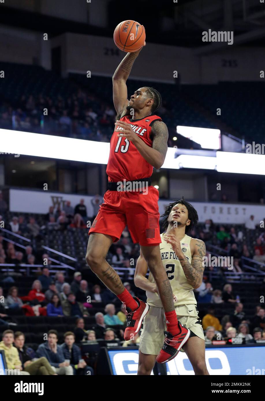 Louisville's V.J. King (13) goes up to dunk past Wake Forest's Sharone ...