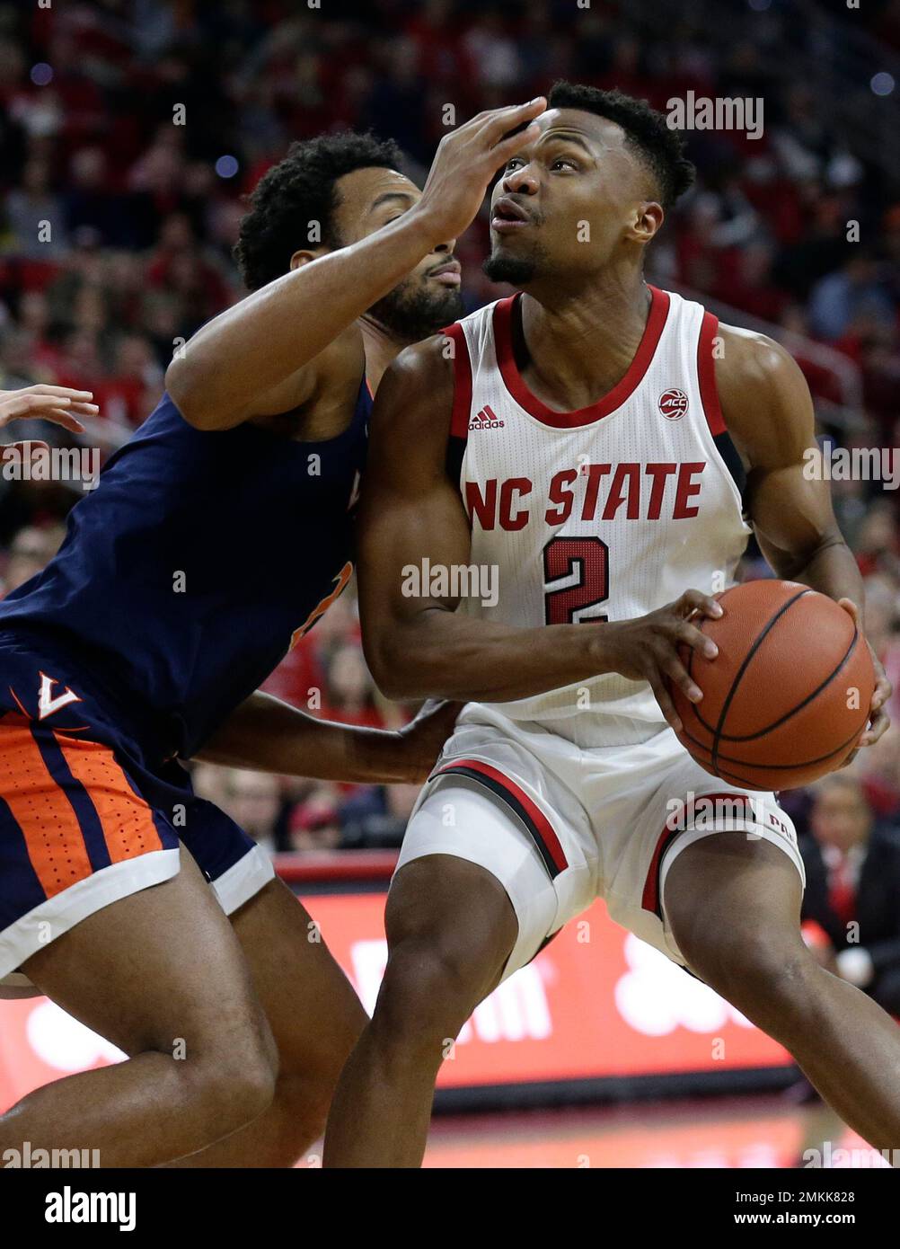 Virginia's Braxton Key guards North Carolina State's Torin Dorn (2 ...