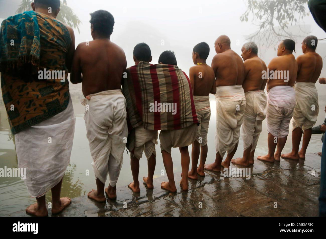Nepalese Devotees pray before taking a holy dip in the river Hanumante ...