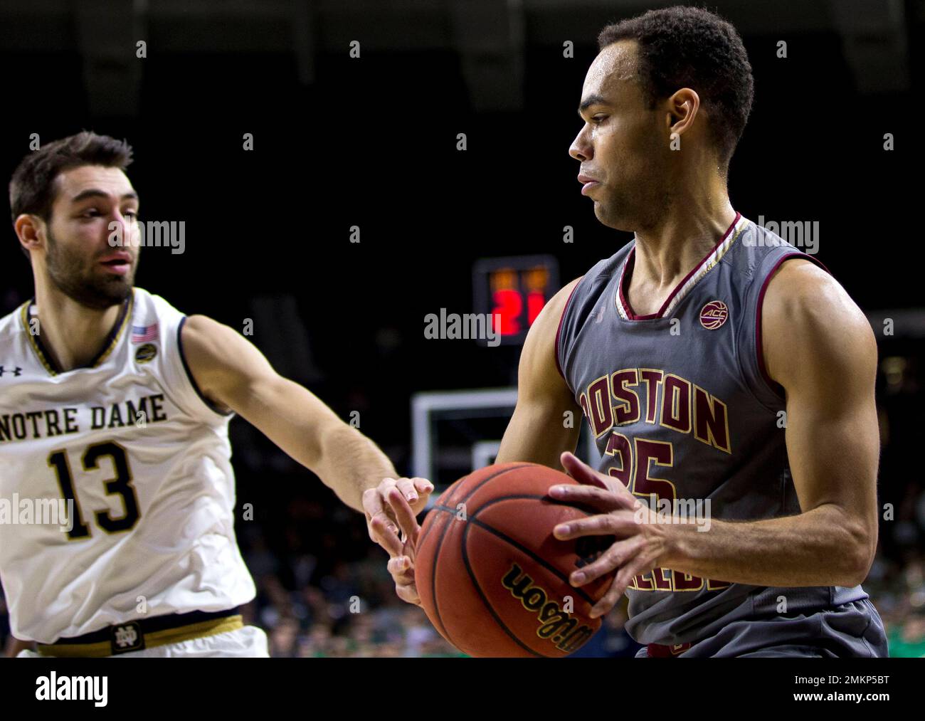 Boston College's Jordan Chatman (25) drives in next to Notre Dame's ...