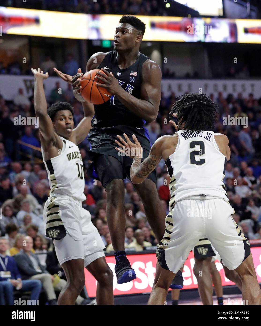 Duke's Zion Williamson, center, droves between Wake Forest's Jaylen ...