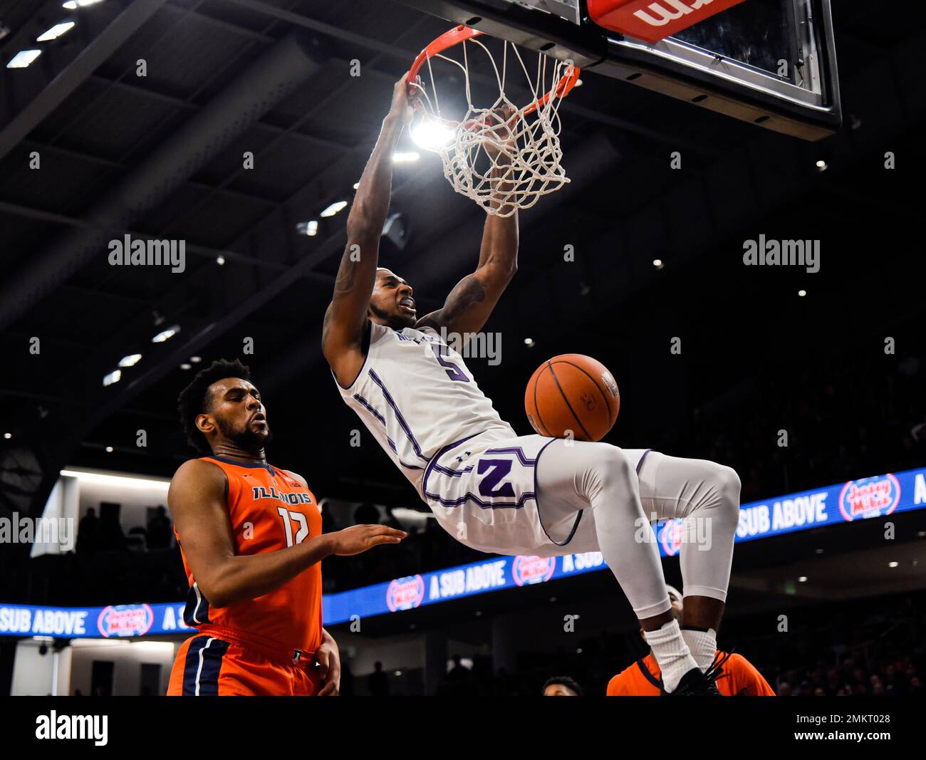 Northwestern center Dererk Pardon (5) dunks past Illinois center Adonis ...