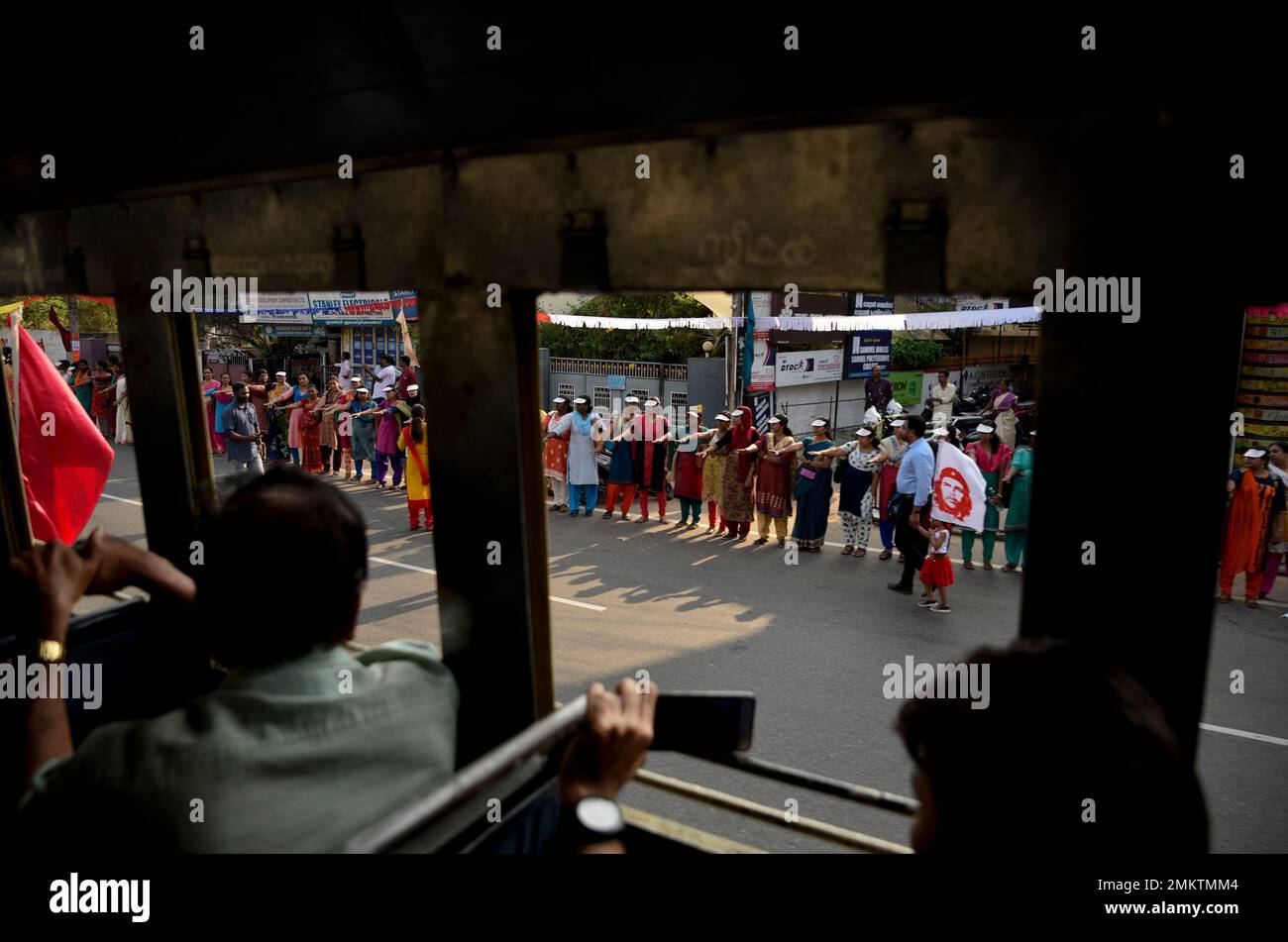 Women raise their hands to take a pledge to fight gender discrimination ...