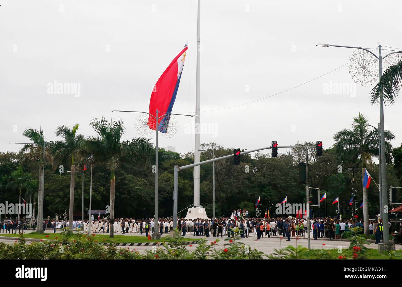 A partly-torn Philippine flag flies briefly at half-mast during ...