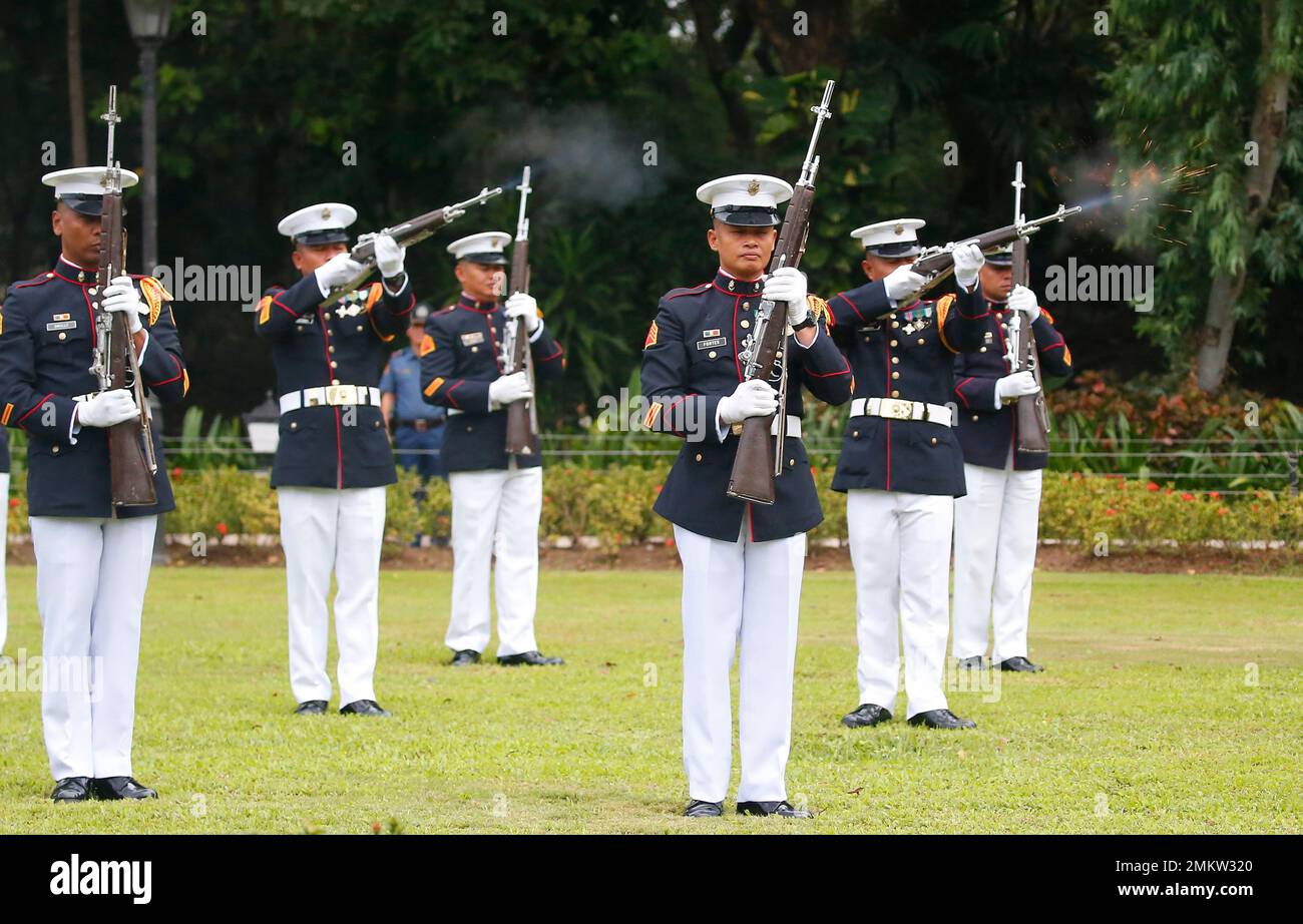Philippine Marine honor guards fire their rifles during flag-raising ...
