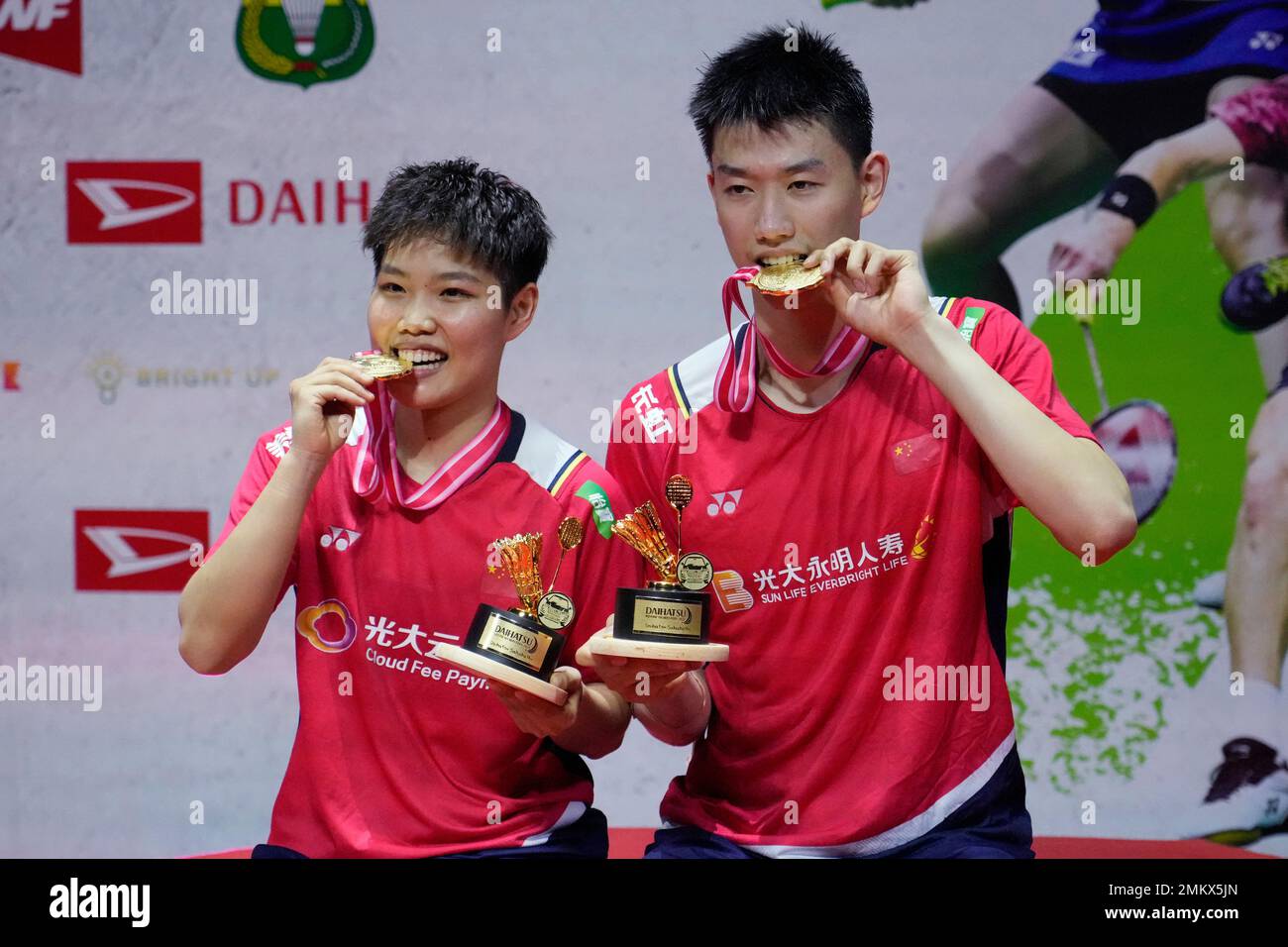 China's Feng Yan Zhe, right, and Huang Dong Ping pose for a photo as they celebrate after ...