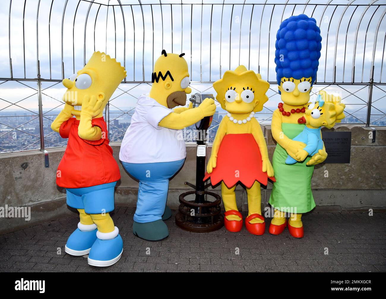 Costumed characters, from left, Bart Simpson, Homer Simpson, Lisa ...