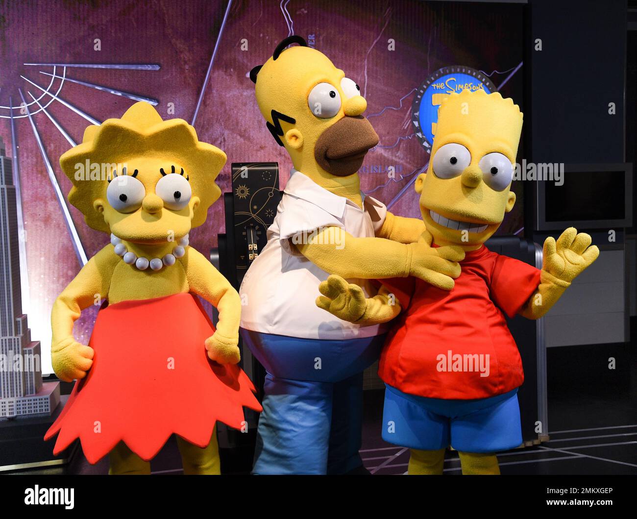 Costumed characters Lisa Simpson, from left, Homer Simpson and Bart ...