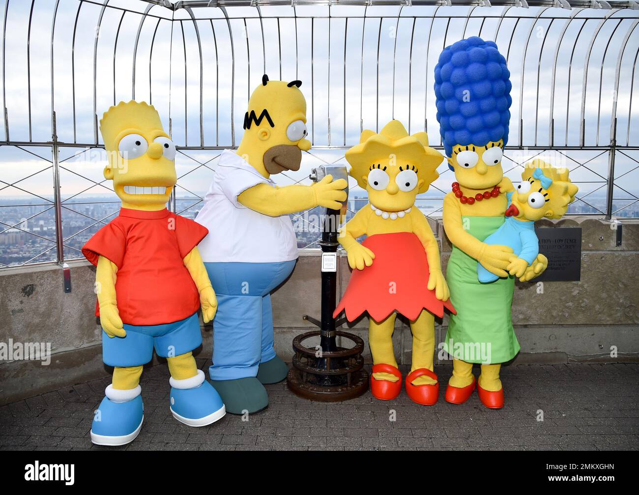 "The Simpsons" costumed characters, from left, Bart Simpson, Homer ...