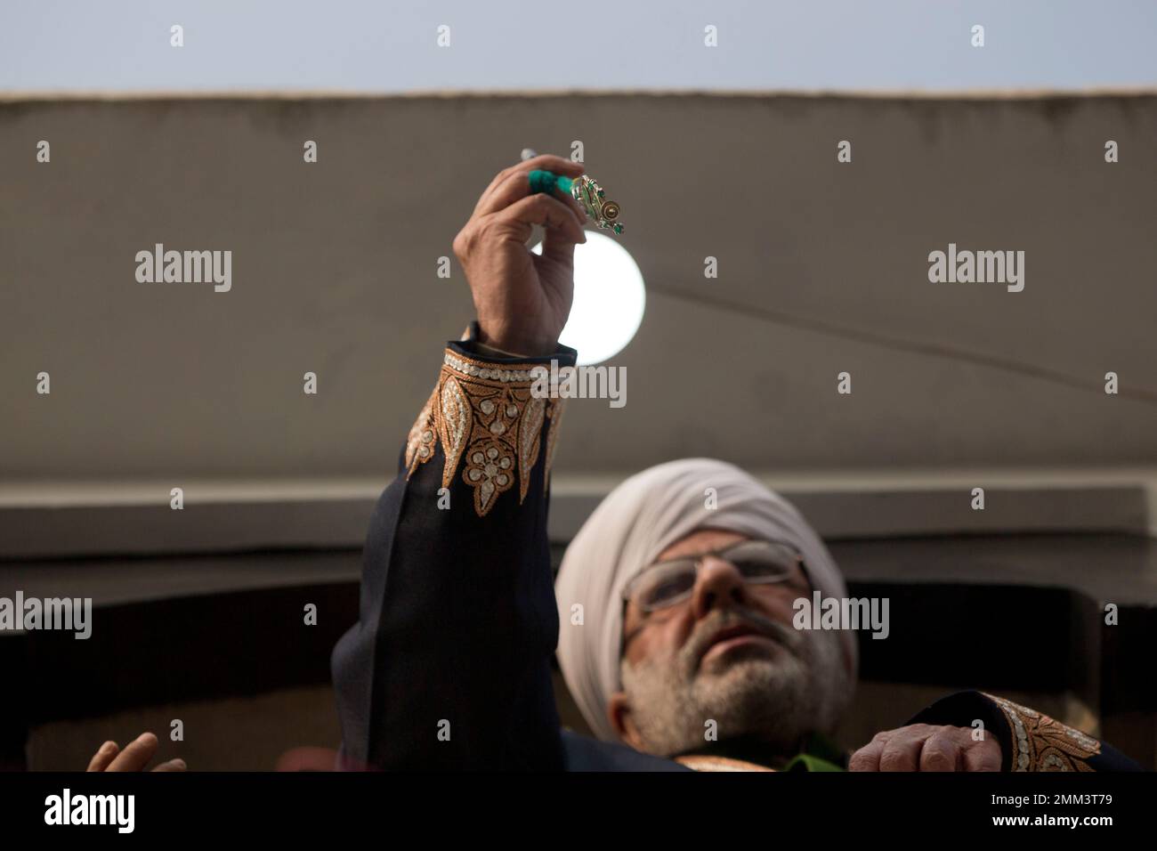 A head priest displays a relic believed to be a hair from the beard of ...