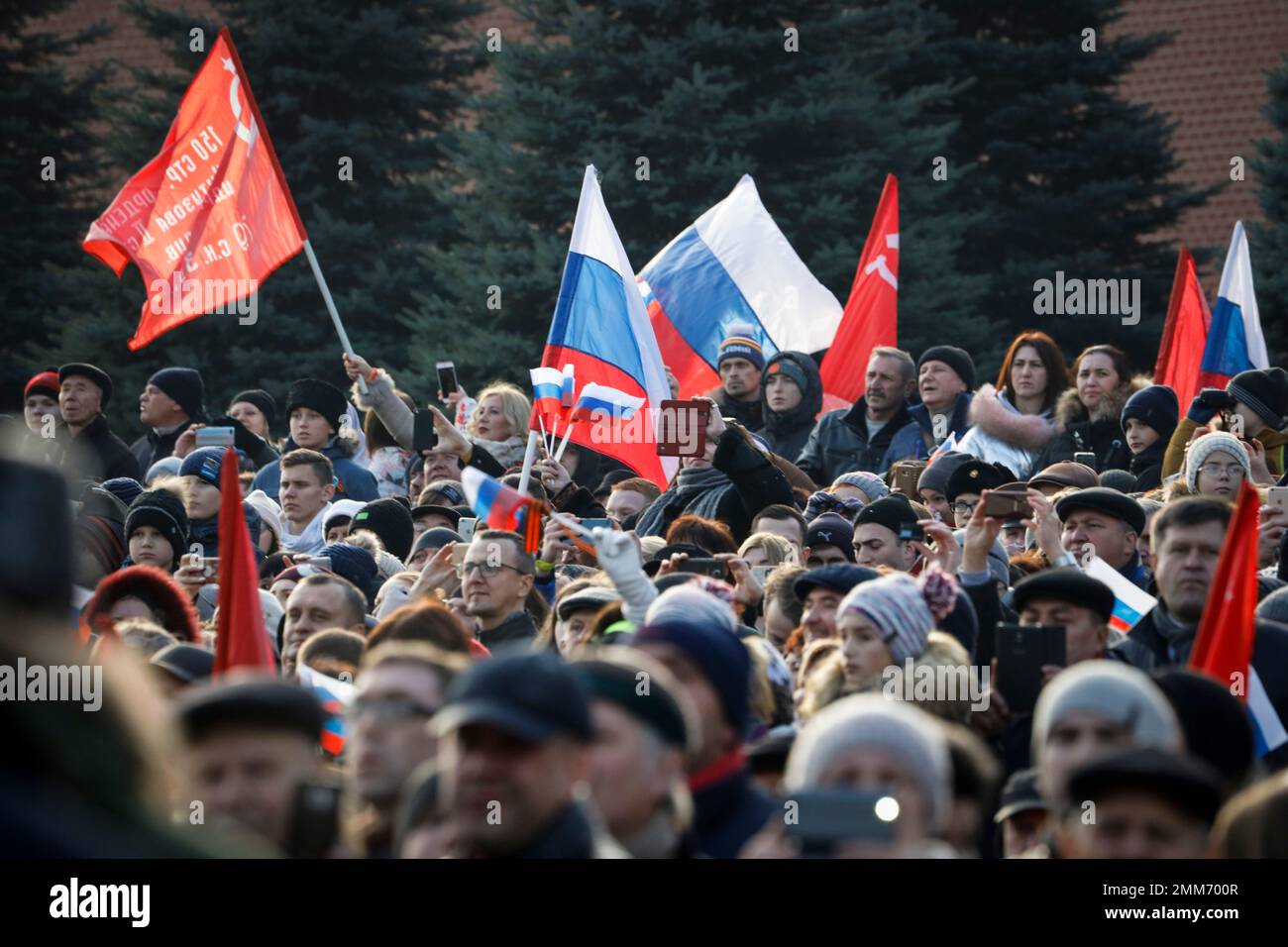 Spectators with Russian national and Red flags watch as Russian ...
