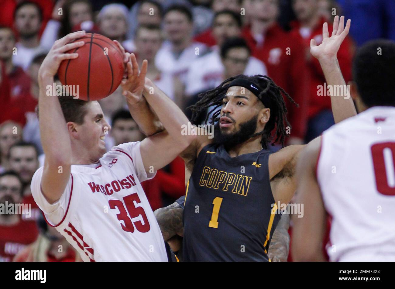 Wisconsin's Nate Reuvers (35) drives on Coppin State's Chad Andrews ...