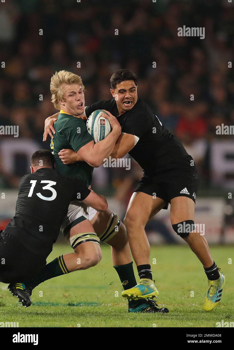 South Africa's Pieter-Steph du Toit, centre, is tackled by New Zealand ...