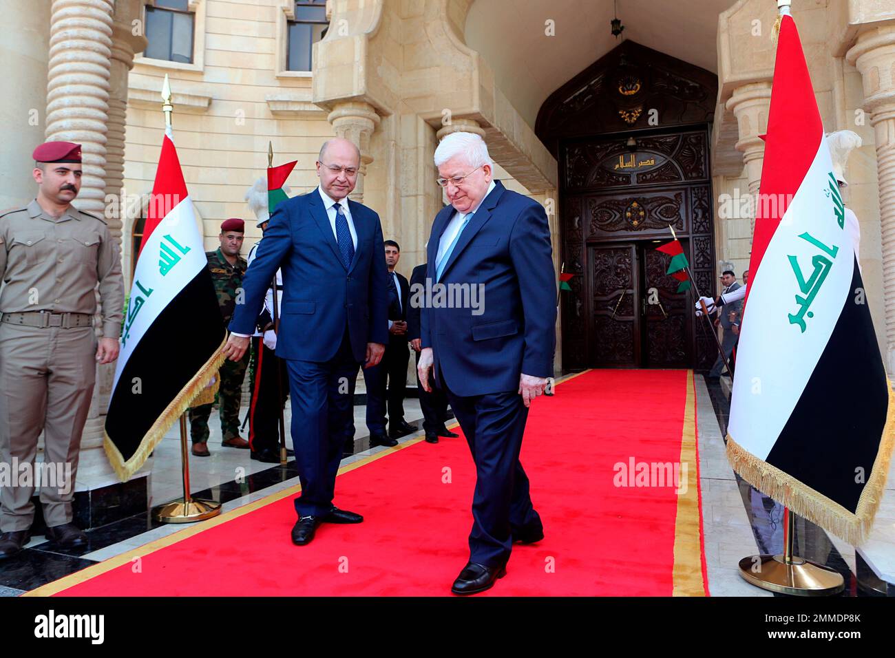 Former Iraqi President Fuad Masum, center, leaves the presidency ...
