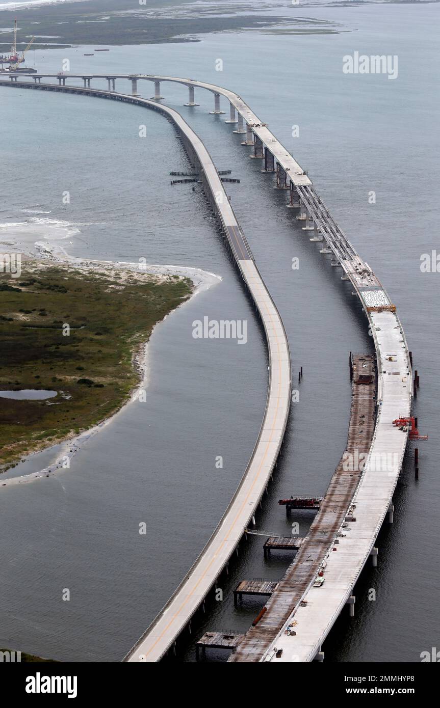 Construction barges are tucked in a protected area around the Bonner ...