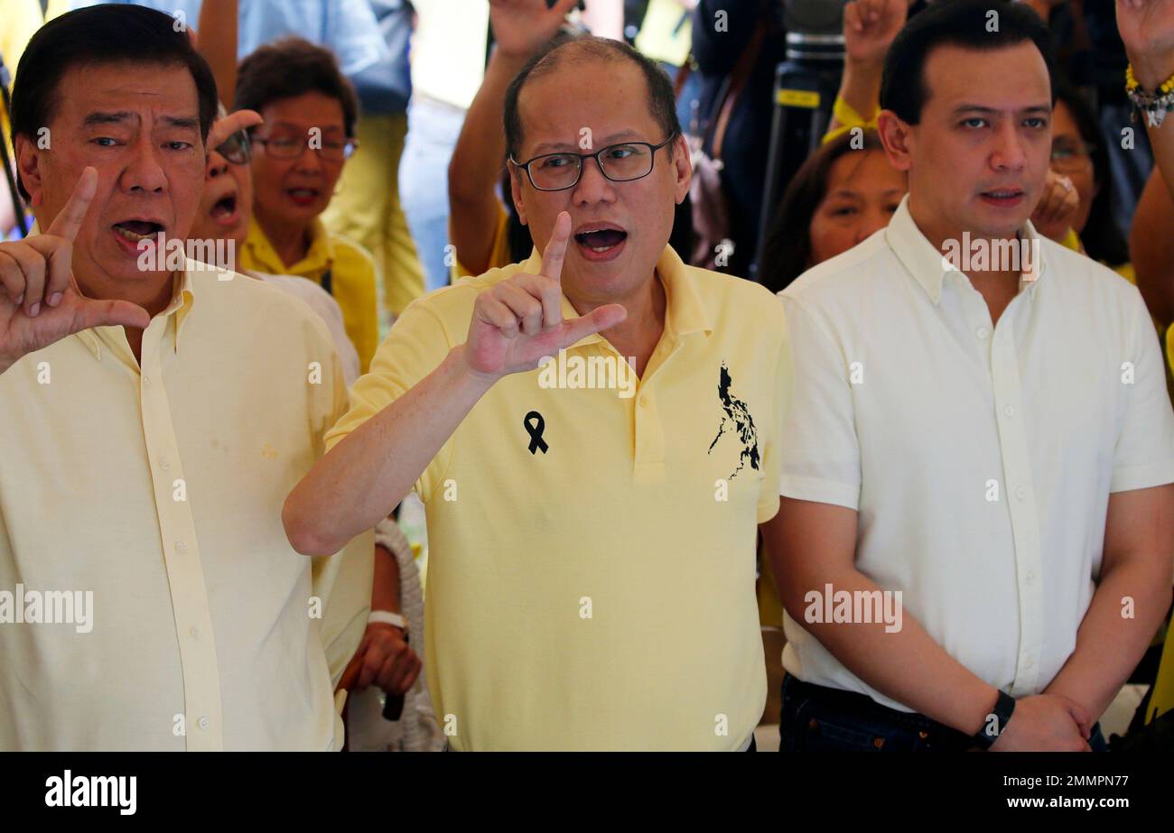 Former President Benigno Aquino III, center, flashes the "L" sign ...