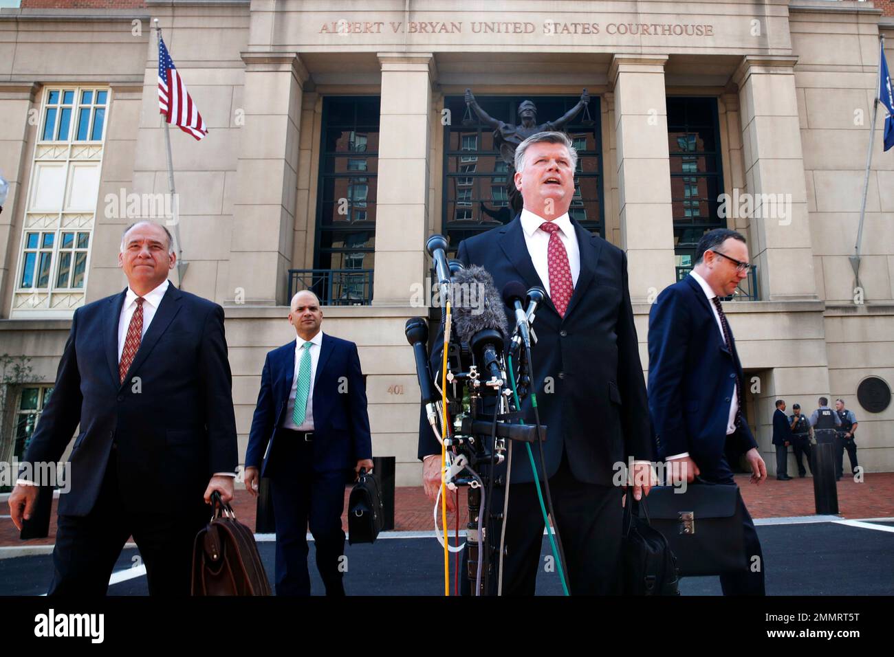 Defense attorney Kevin Downing, second from right, makes a statement to ...