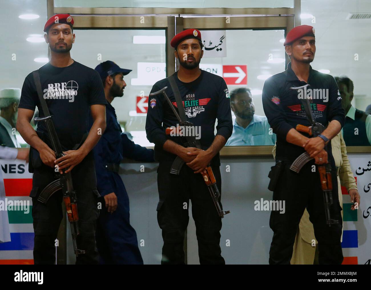 Pakistani police commandos stand guard outside the cardiac ward, where ...