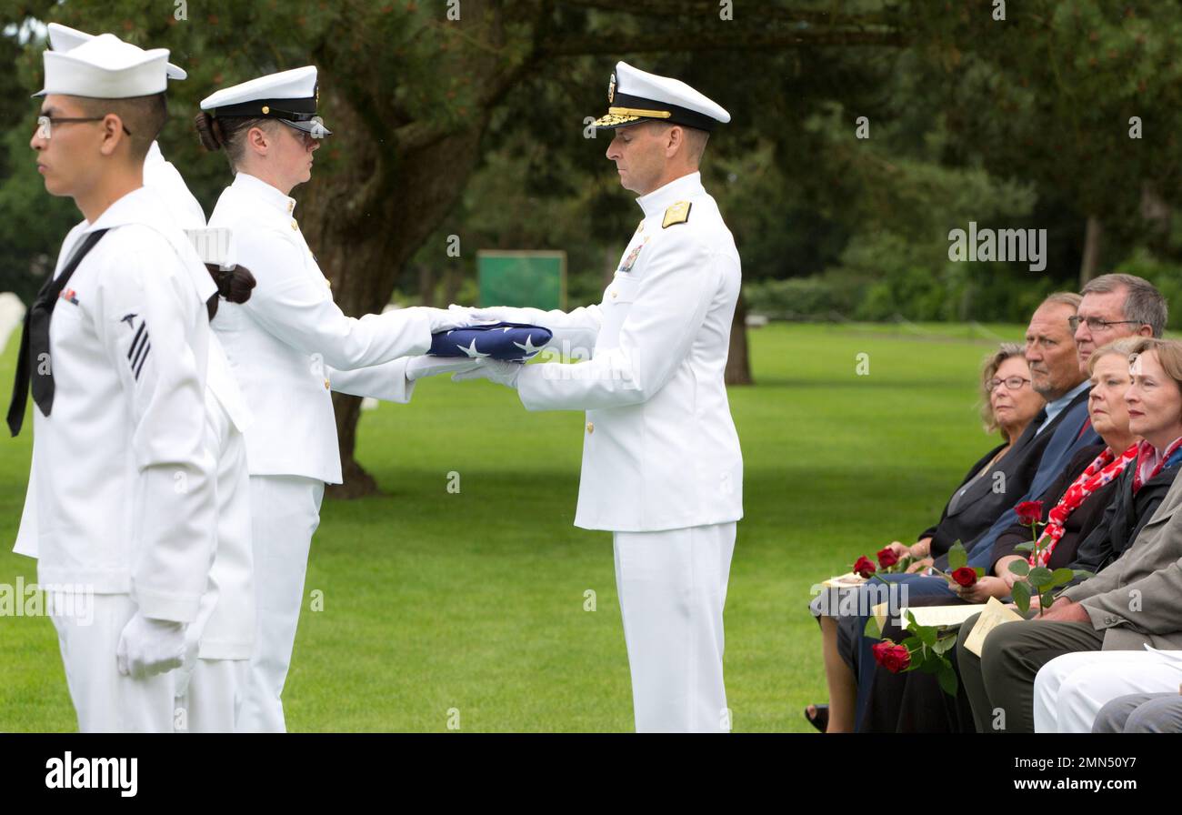 A U.S. Navy sailor performs a handover ceremony of the flag from WWII U ...